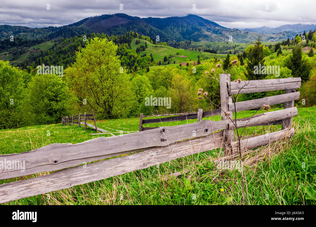 wooden fence on hillside in the rural area. classic countryside ...