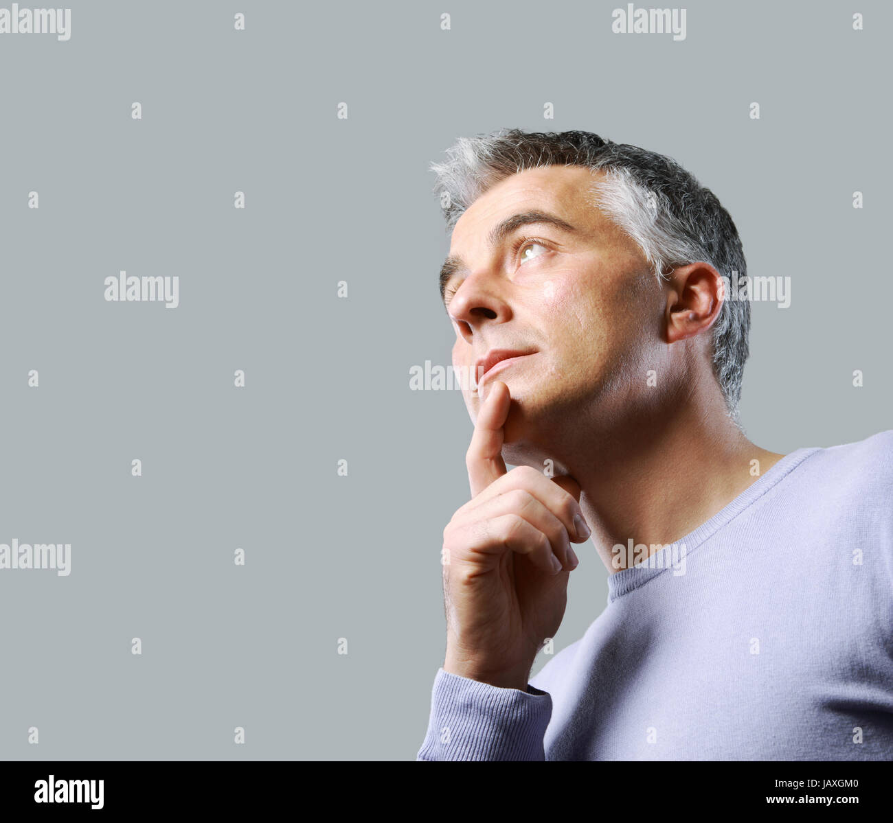 Portrait of casual man thinking and looking up Stock Photo - Alamy