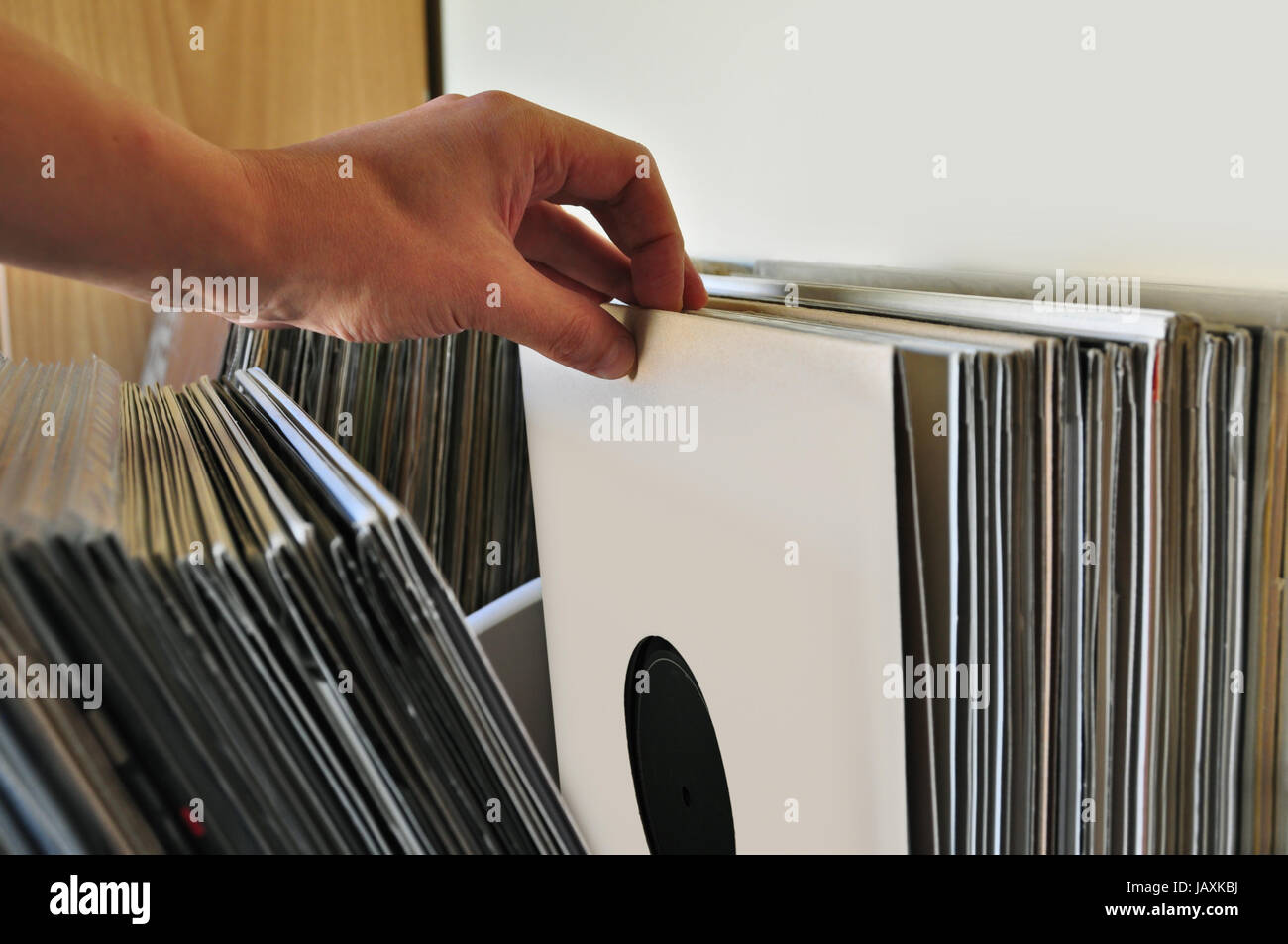 Browsing through vinyl records collection. Music background Stock Photo ...