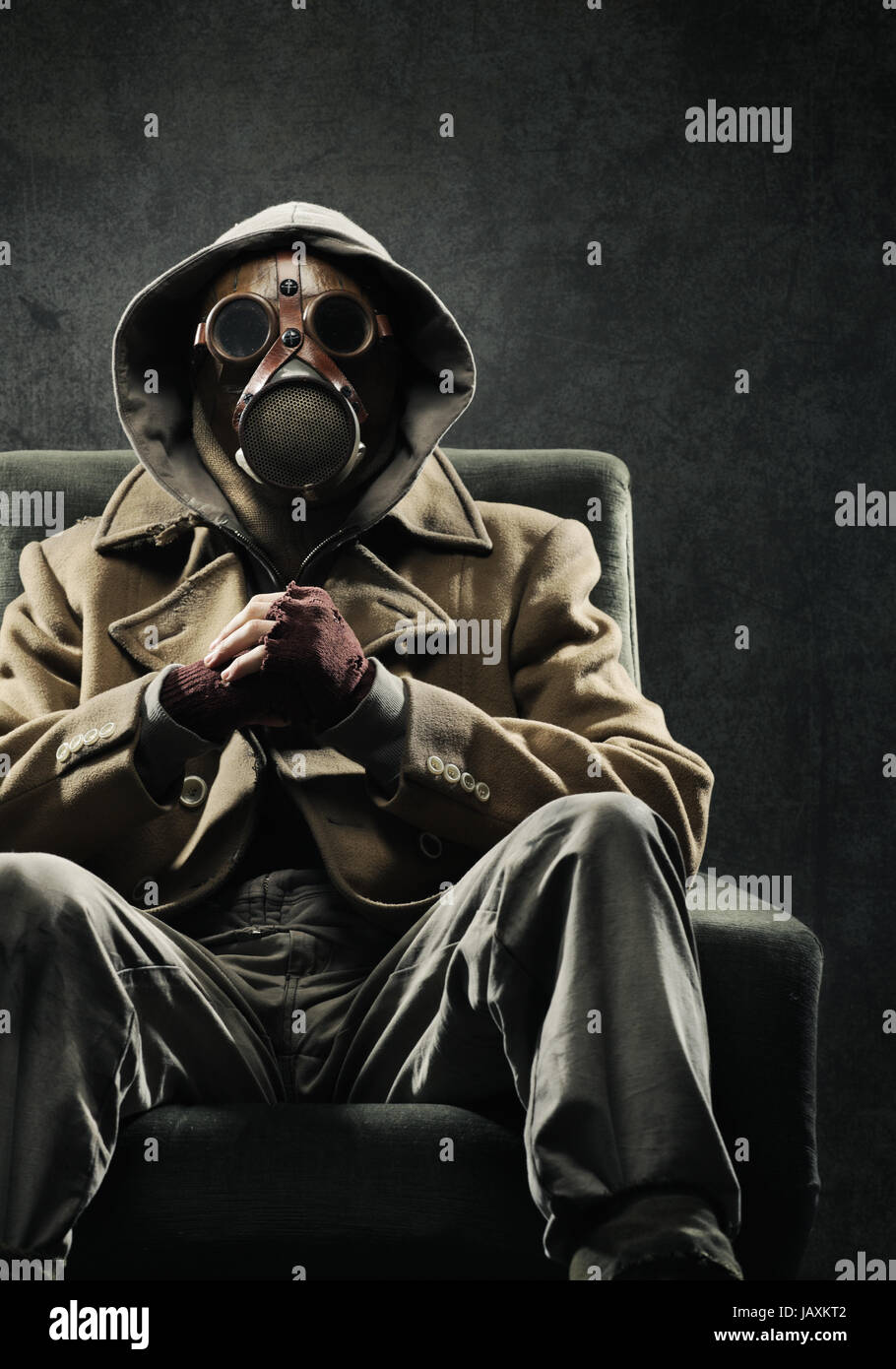 Man in gas mask sitting in a chair Stock Photo - Alamy