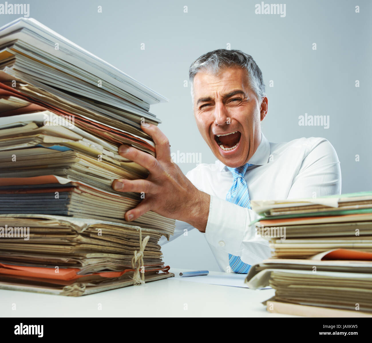Overworked mature business man screaming in anger Stock Photo - Alamy