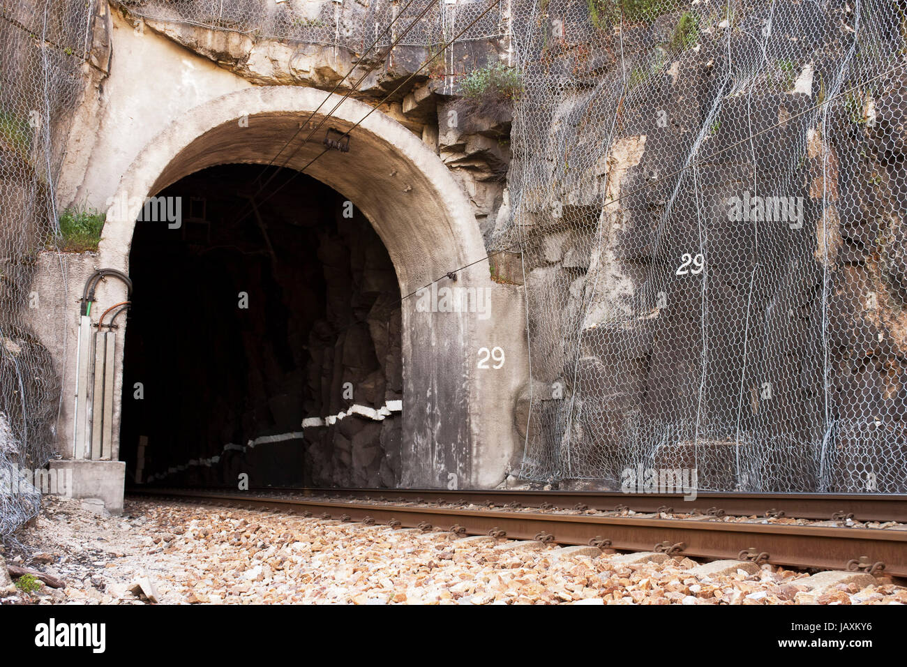 The portal of a tunnel on the railway Stock Photo - Alamy