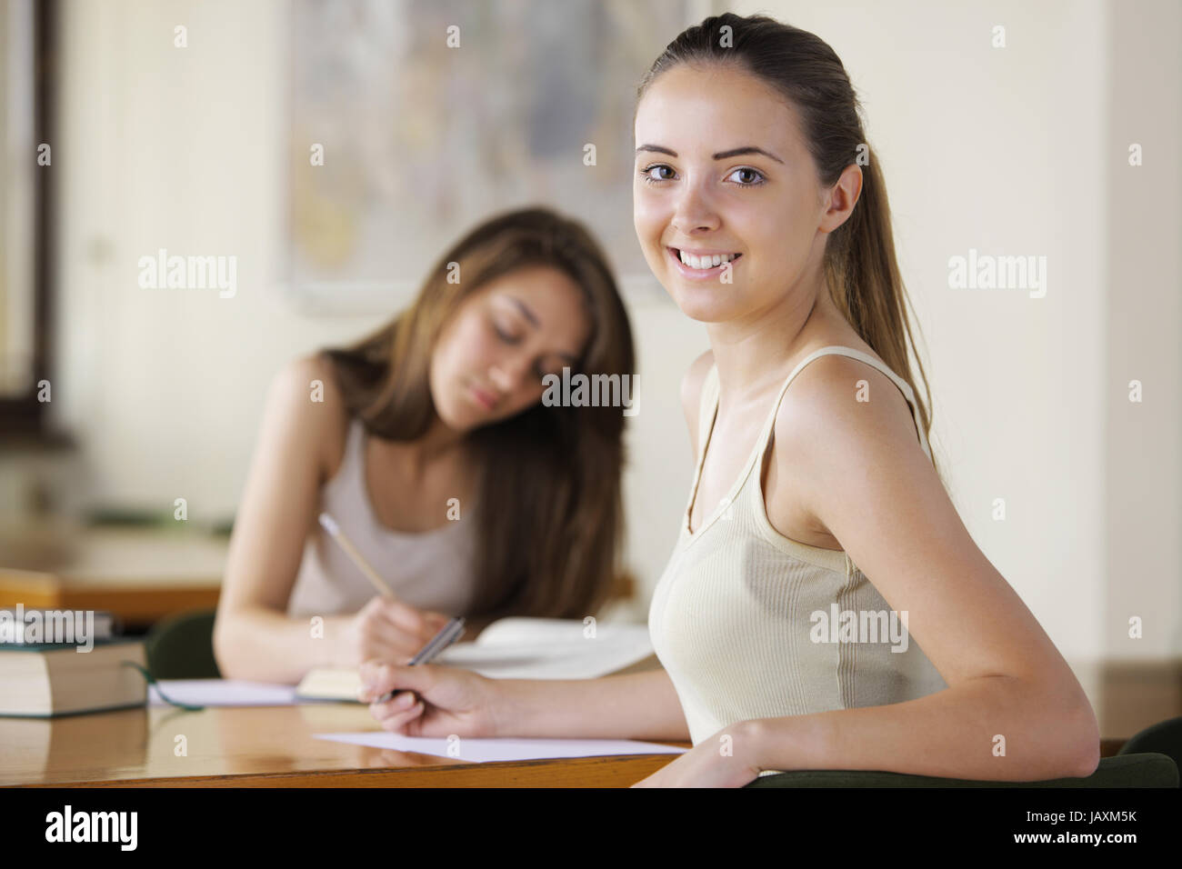 Portrait of a student, a young woman studying in the background Stock ...