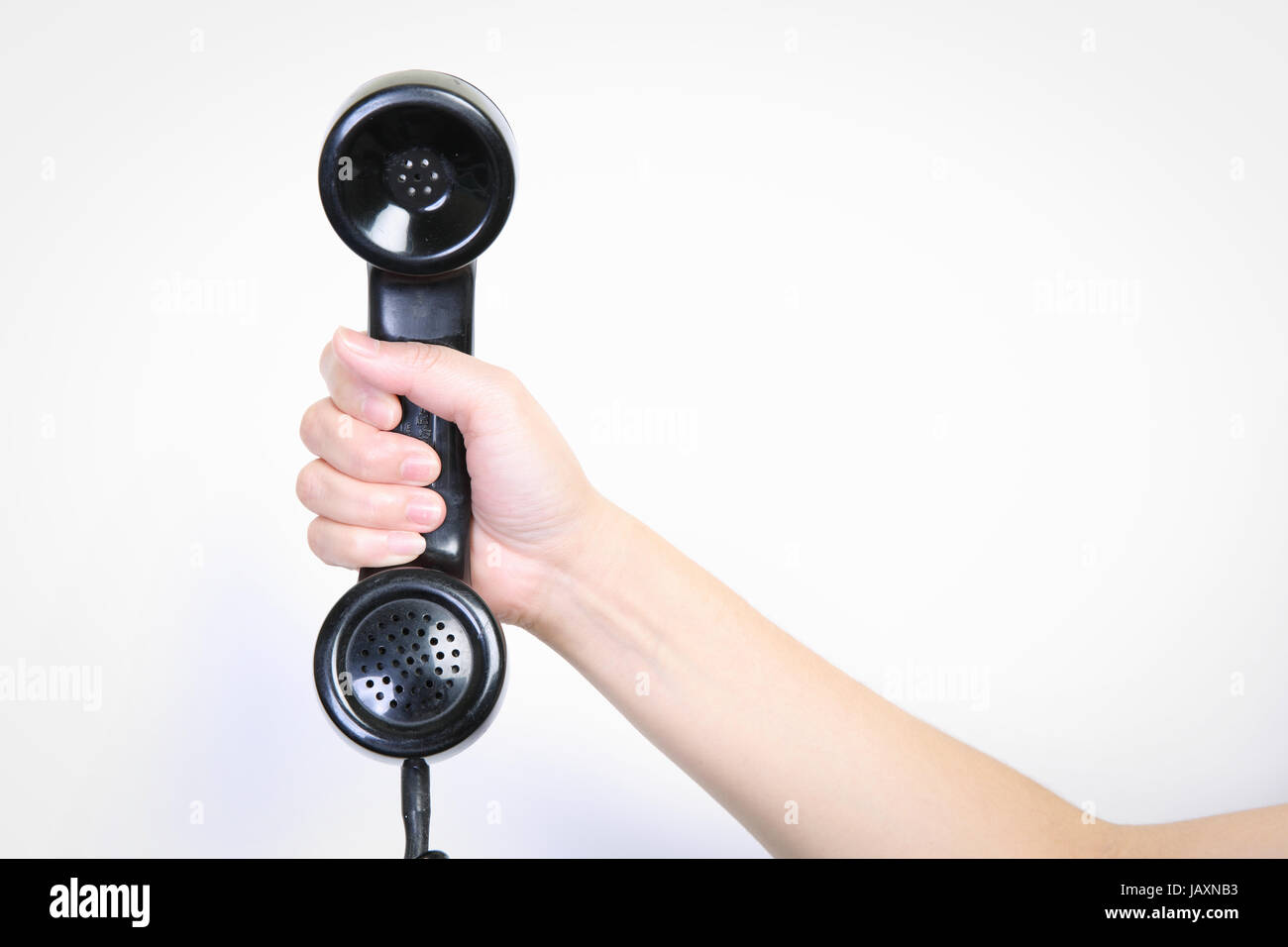 Close Up Of hand holding telephone against a white background Stock ...
