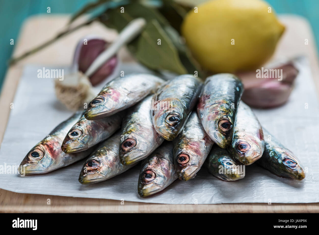 Fresh raw sardines on the table of the kitchen to be cooked Stock Photo ...