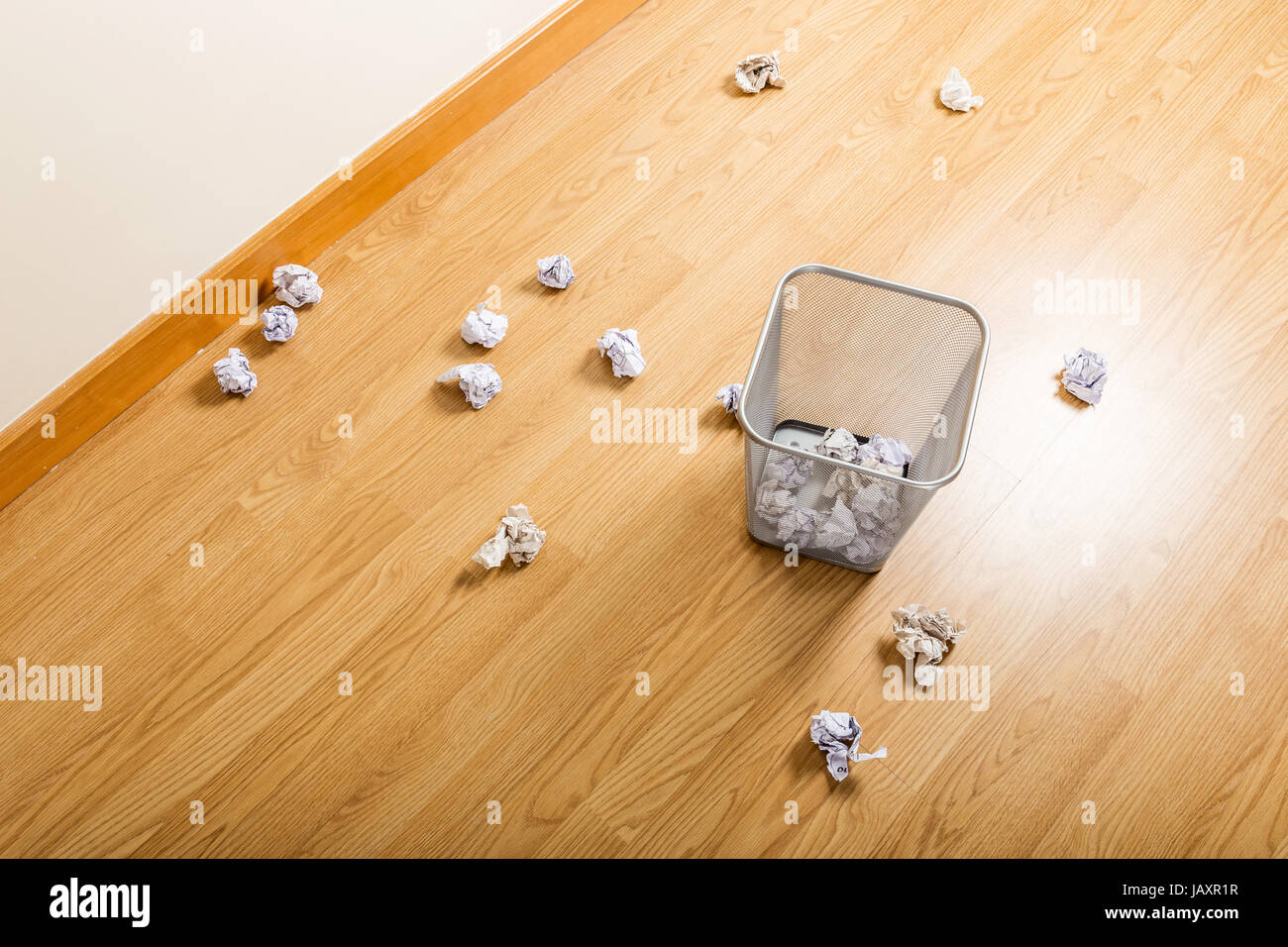 Metal trash bin and crumpled paper ball Stock Photo - Alamy
