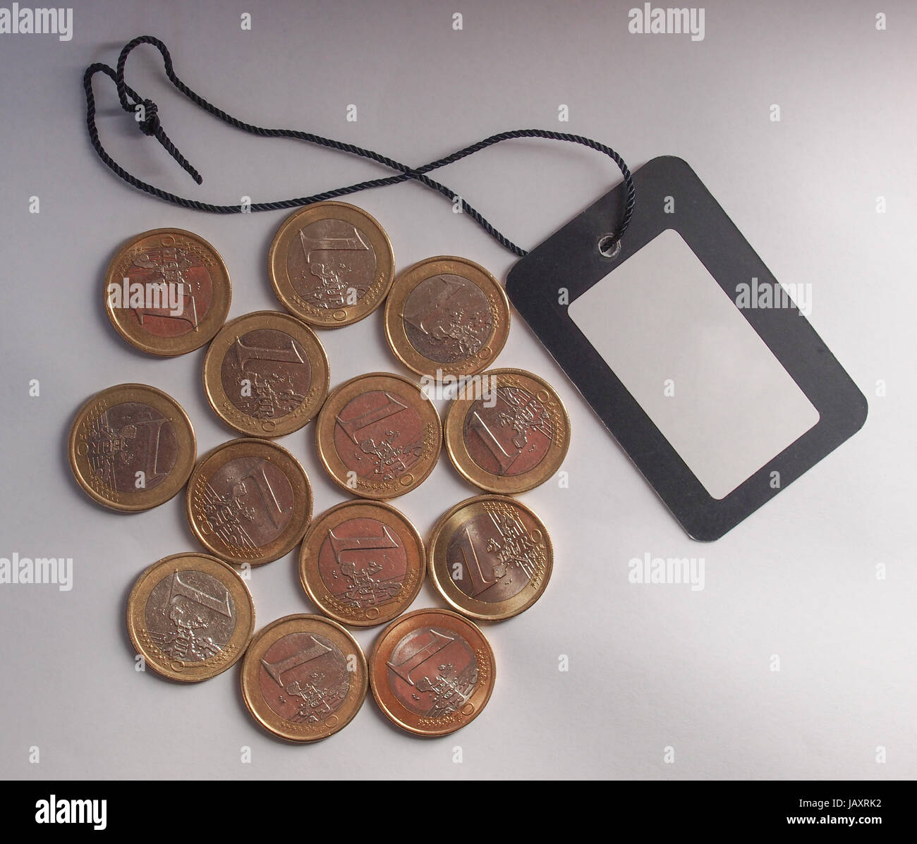 Many Euro coins (currency of the European Union) with price tag label ...