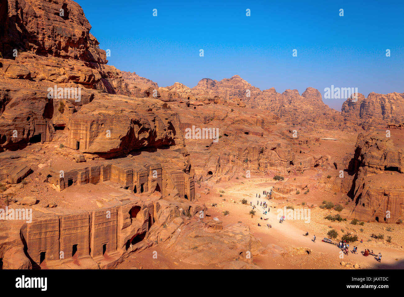View of desert and ancient tombs carved in the rock in Petra, Jordan ...