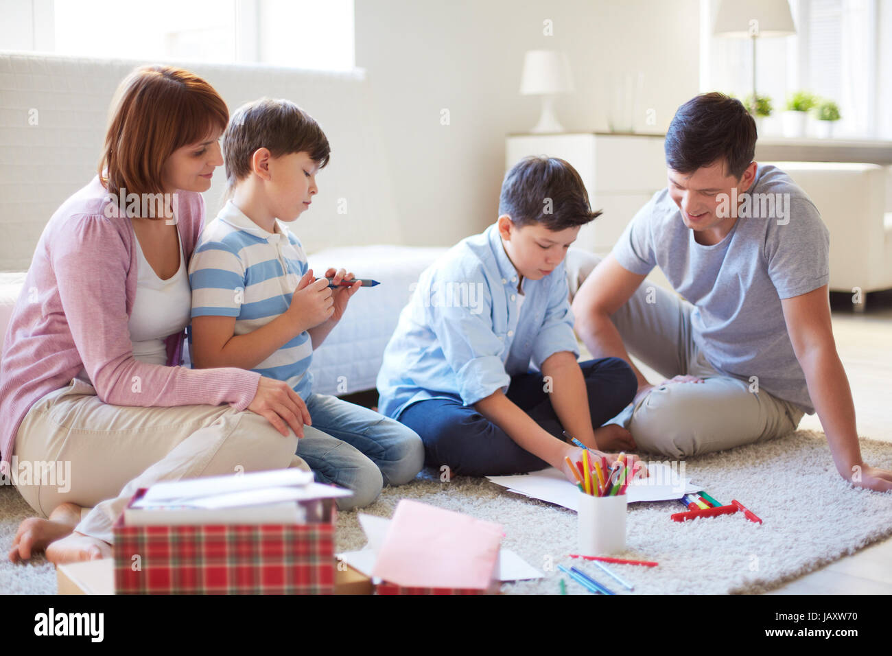 Portrait of friendly family drawing together at home Stock Photo - Alamy