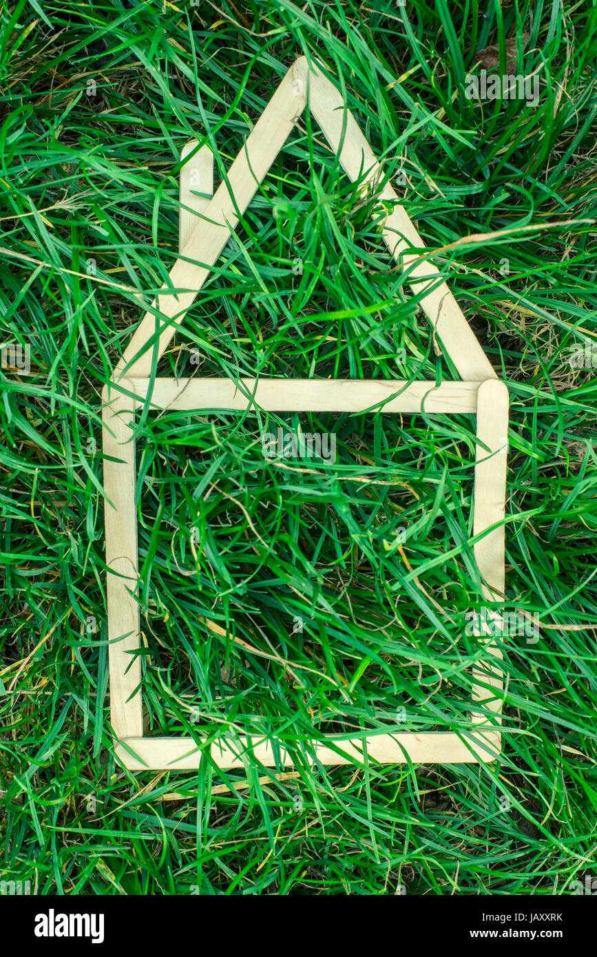 Model house made of wooden sticks on green grass Stock Photo - Alamy