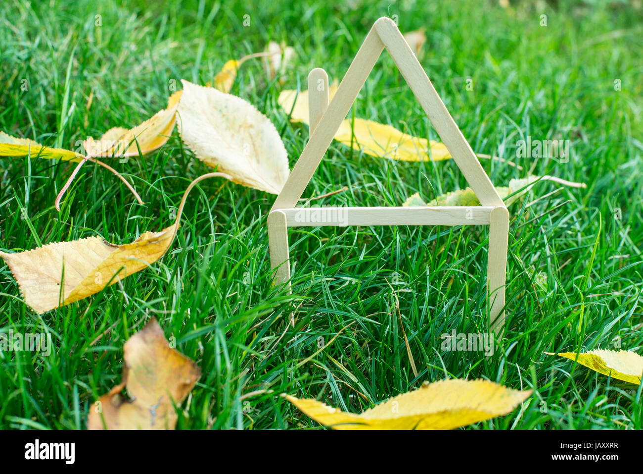 Model house made of wooden sticks on green grass Stock Photo - Alamy