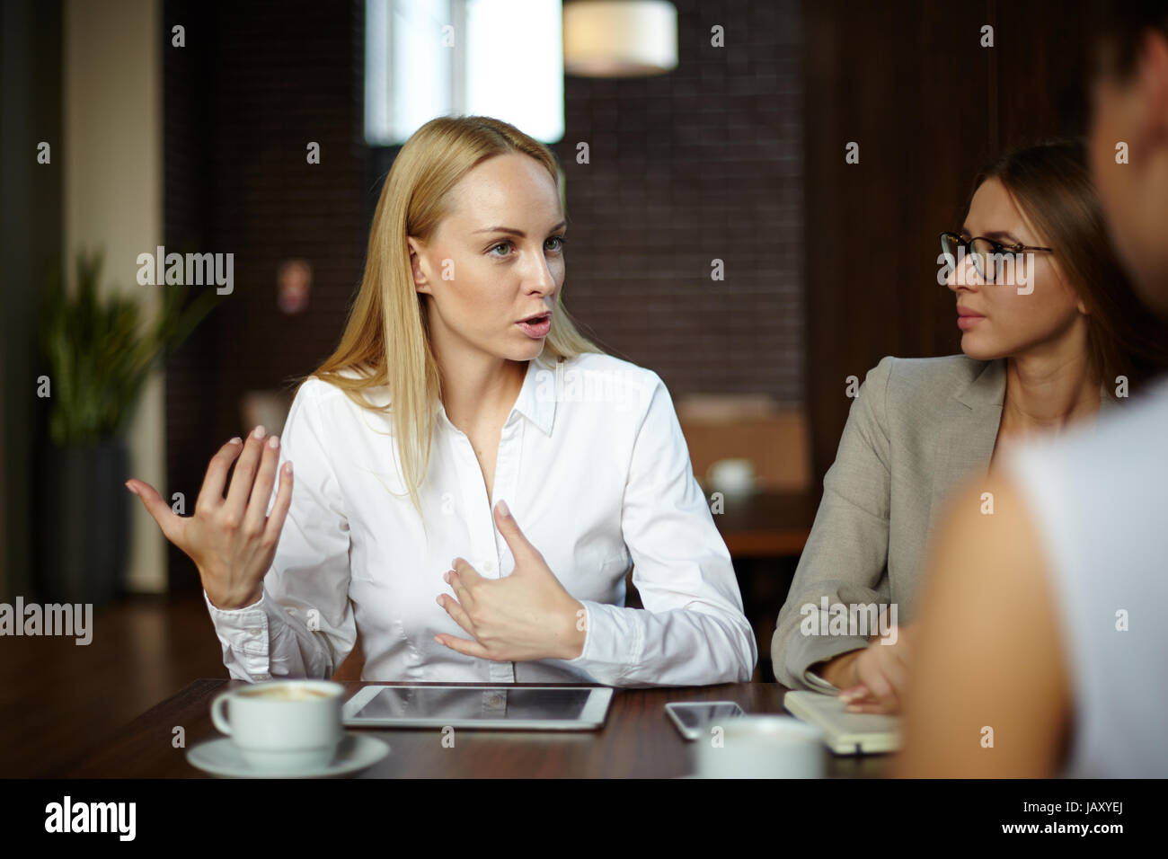 Work Meeting of Pretty Colleagues Stock Photo - Alamy