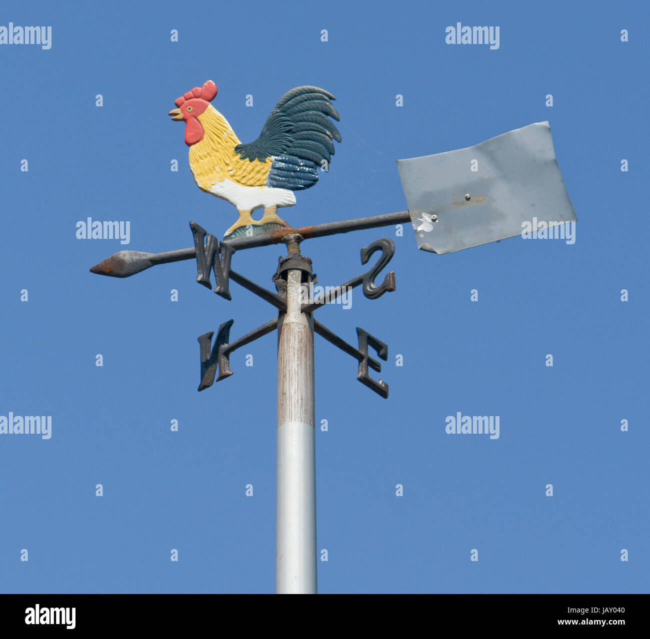 a sunny illuminated weathercock in front of blue sky Stock Photo - Alamy