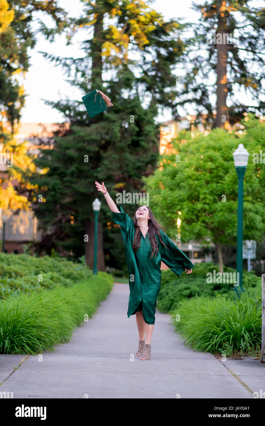 College grad student throwing hat in the air before graduation ...