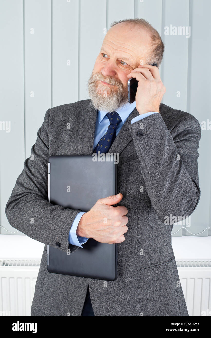 Picture of a confident businessman having a phone call Stock Photo - Alamy