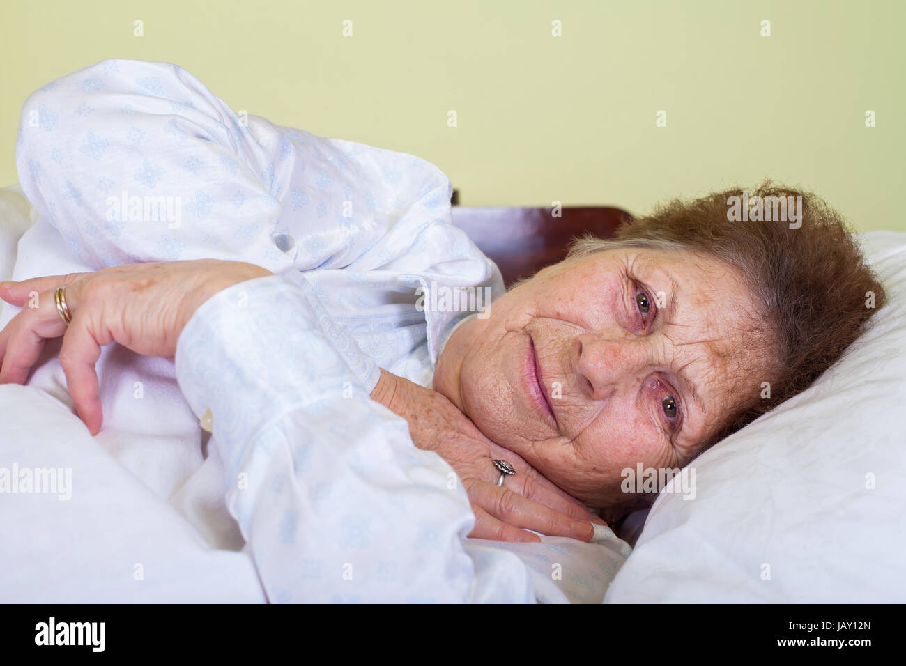 Picture of a sick old lady in bed at home Stock Photo - Alamy