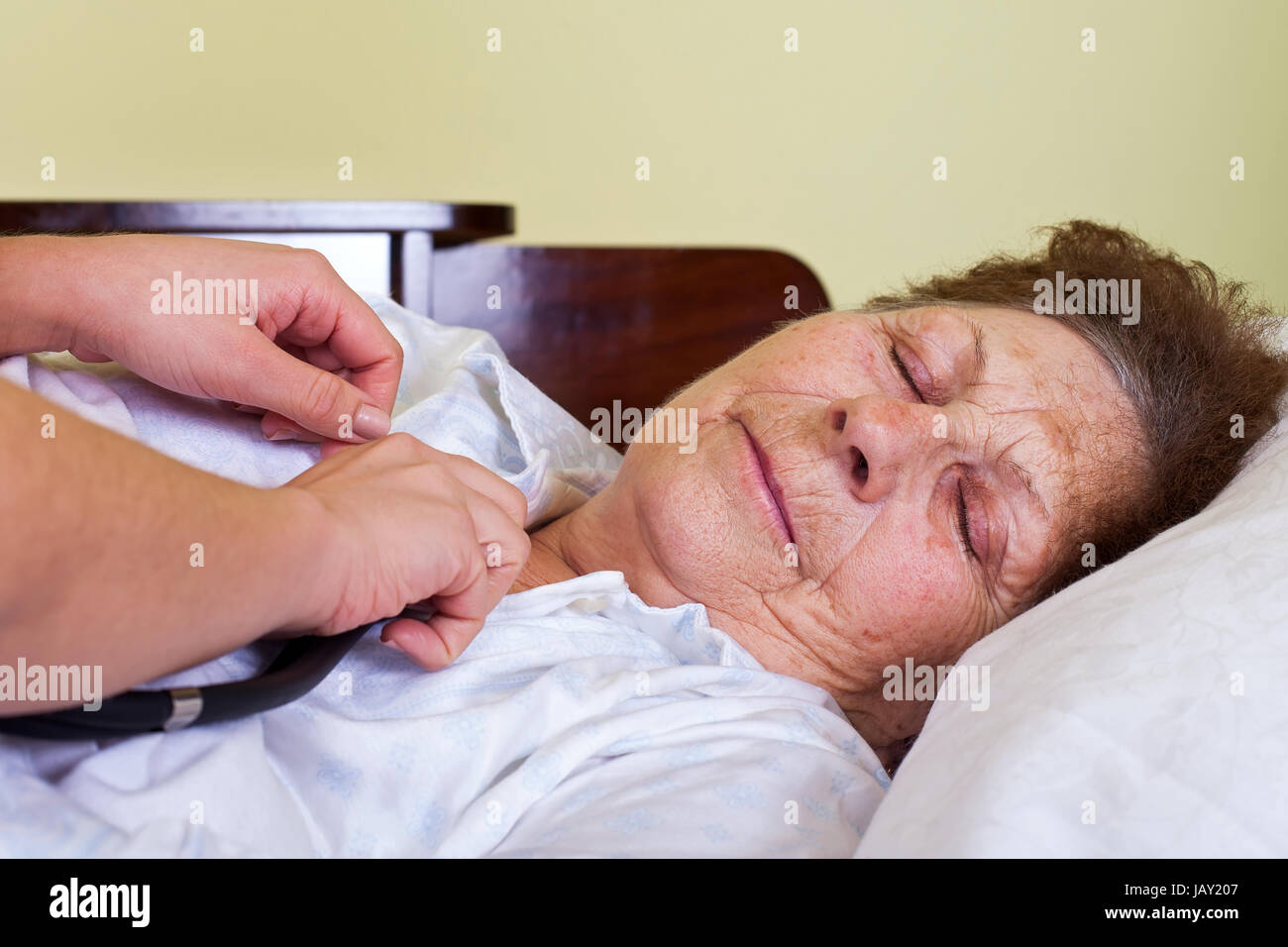 Picture of a bed ridden elderly woman with her carer Stock Photo - Alamy