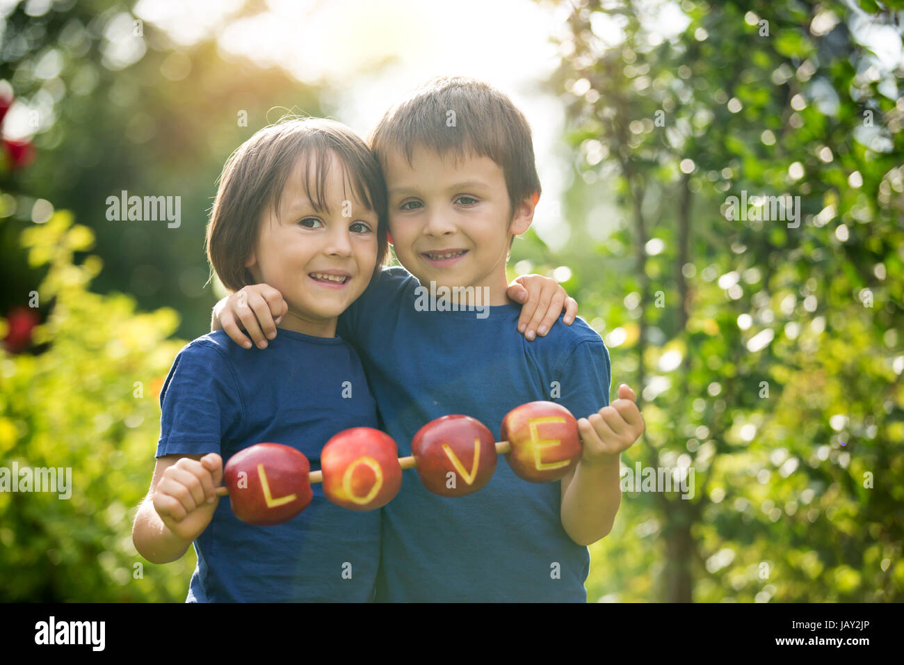 Cute little children, boy brothers, holding a love sign, made from ...