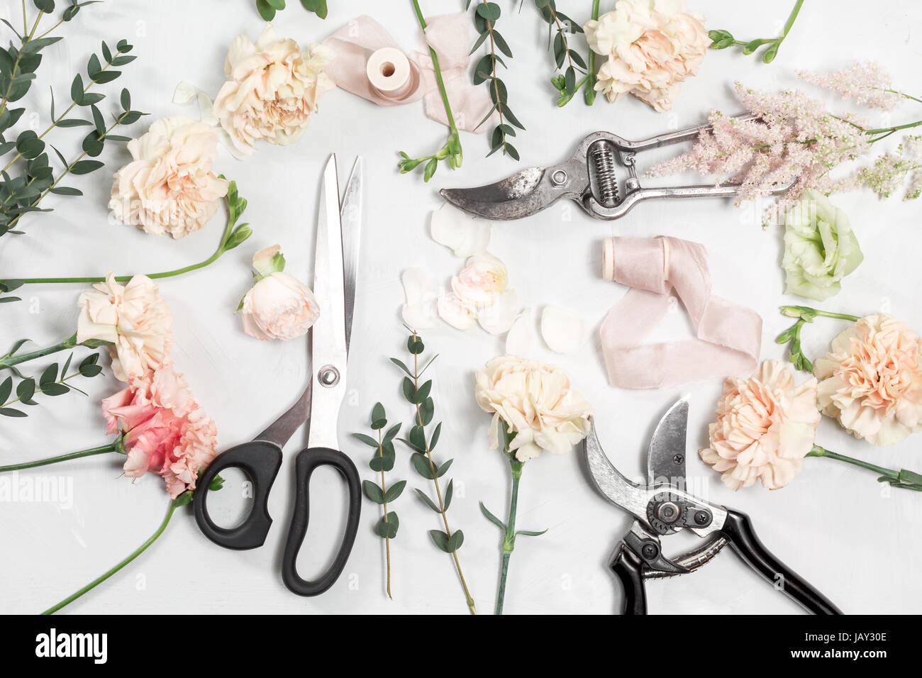 flowers and garden tools. The florist work table with accessories light ...