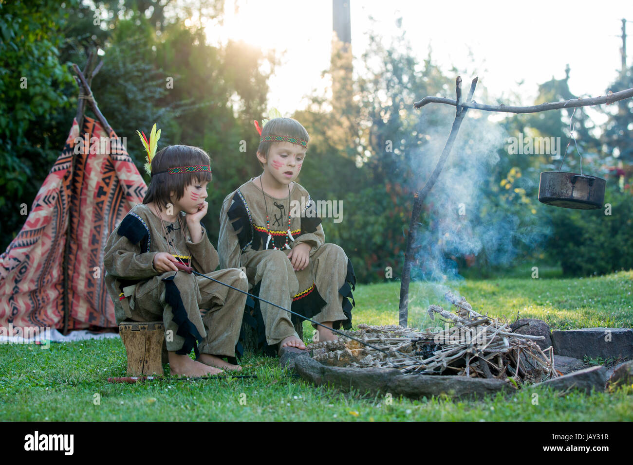 Cute portrait of native american boys with costumes, playing outdoor ...