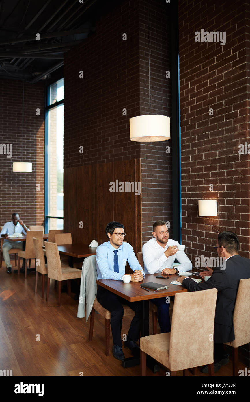 Male Colleagues Having Coffee Break Stock Photo - Alamy