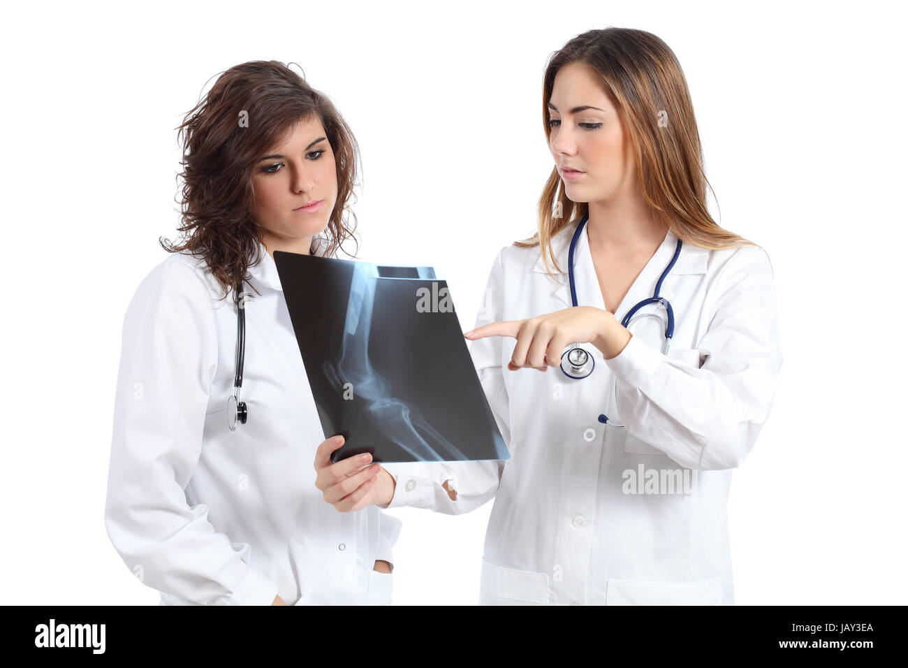 Two female doctors watching a radiography isolated on a white ...