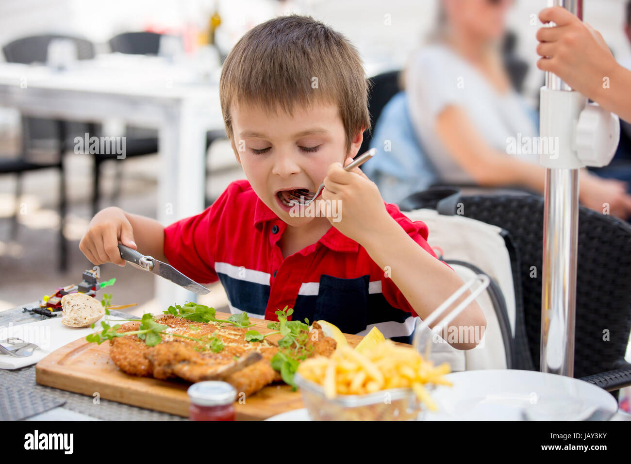 Child eating restaurant fork hi-res stock photography and images - Alamy