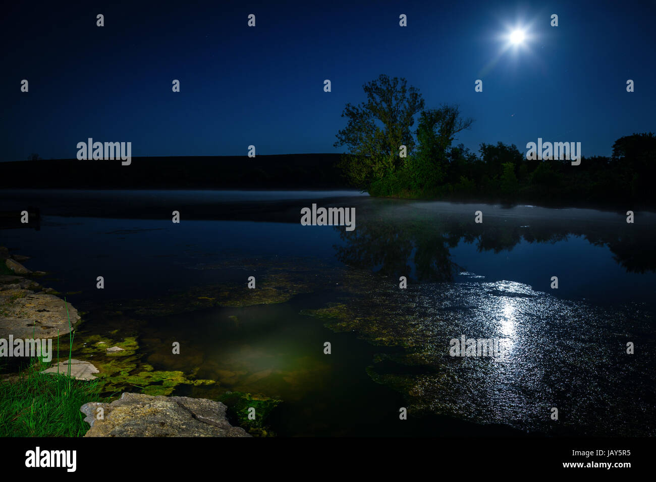 Scenic nighttime landscape with full moon rising over the lake Stock ...