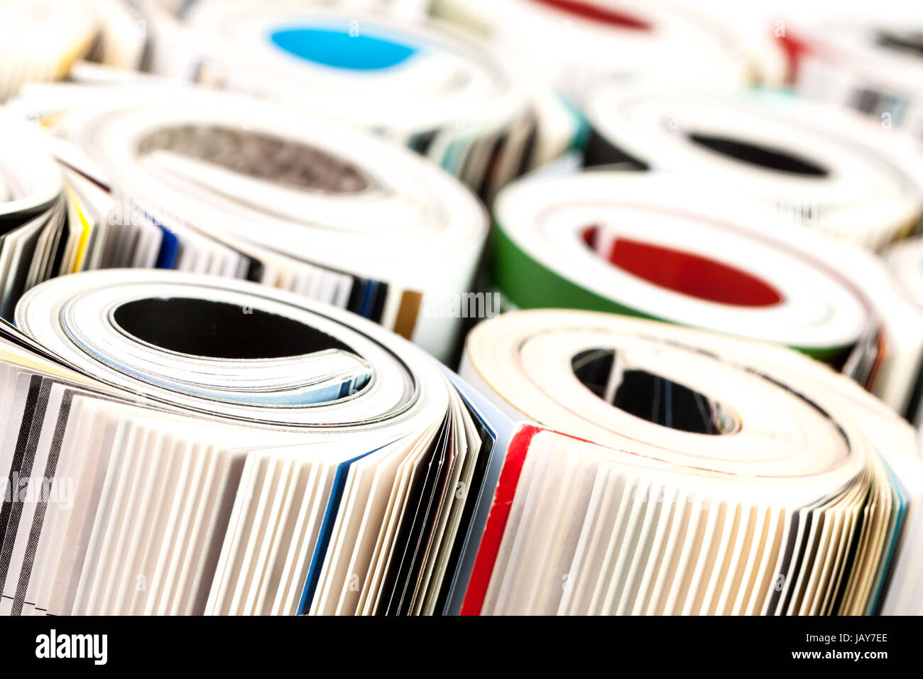 Stack of color magazines on white background Stock Photo - Alamy