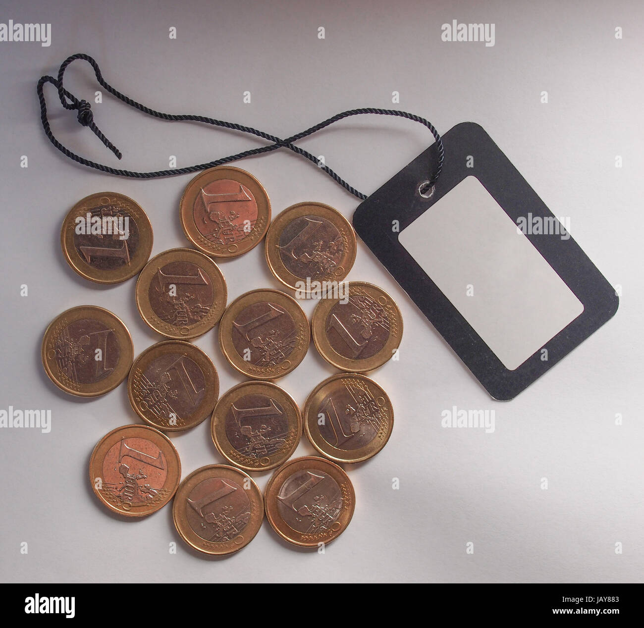 Many Euro coins (currency of the European Union) with price tag label ...