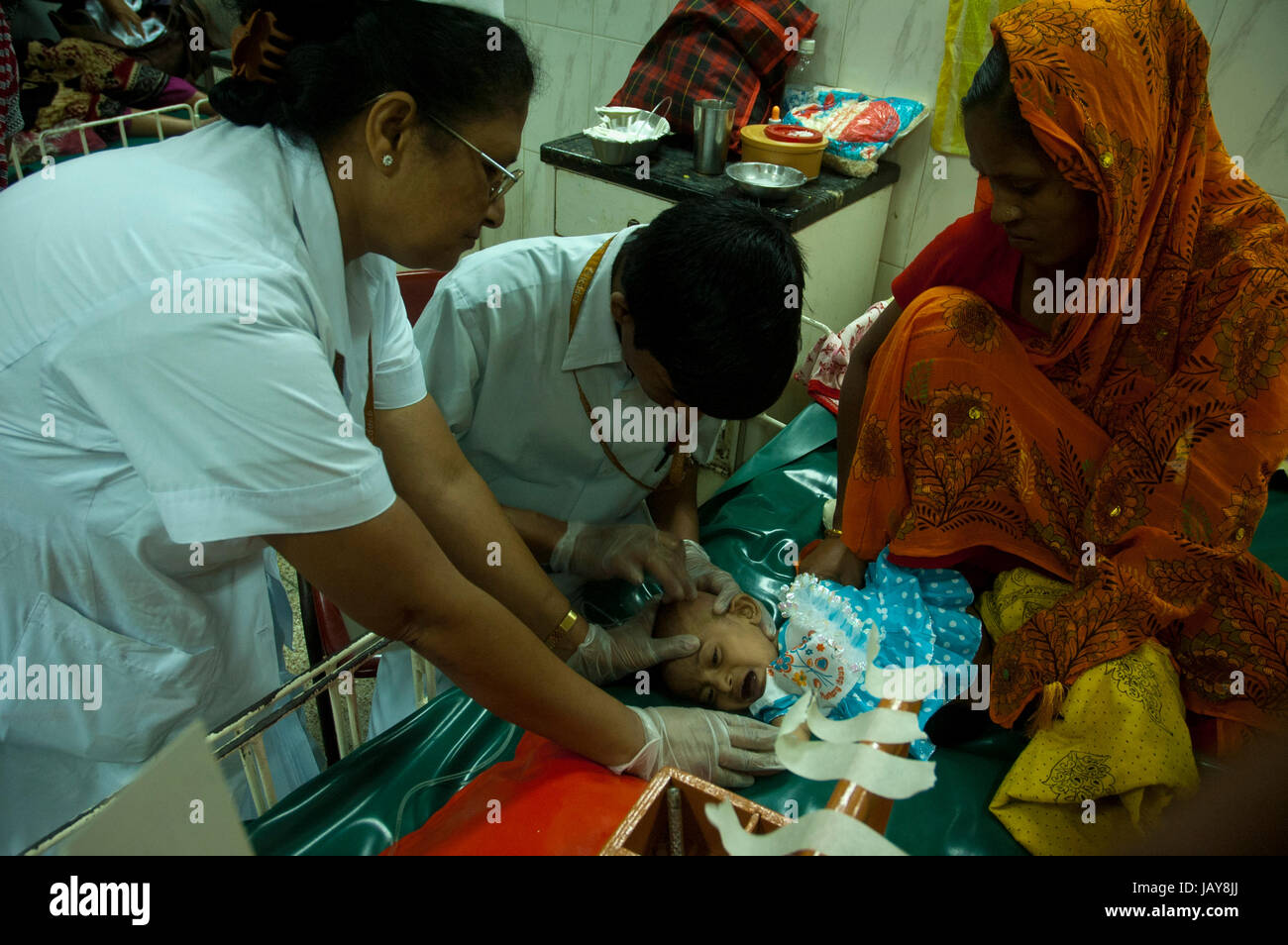 Doctor treating an infant at the “International Centre for Diarrhoeal ...