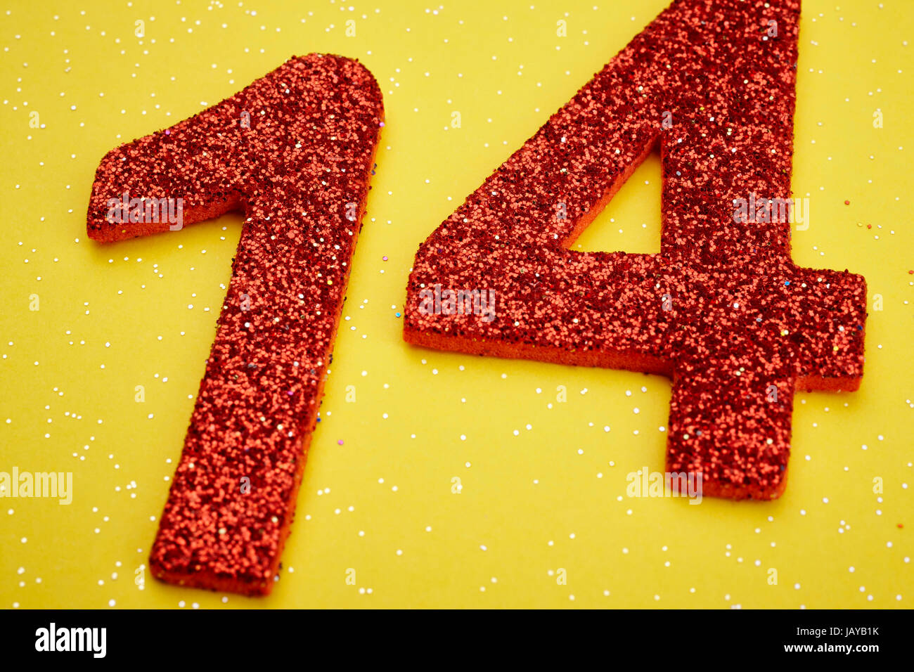 Number fourteen red color over a yellow background. Anniversary ...
