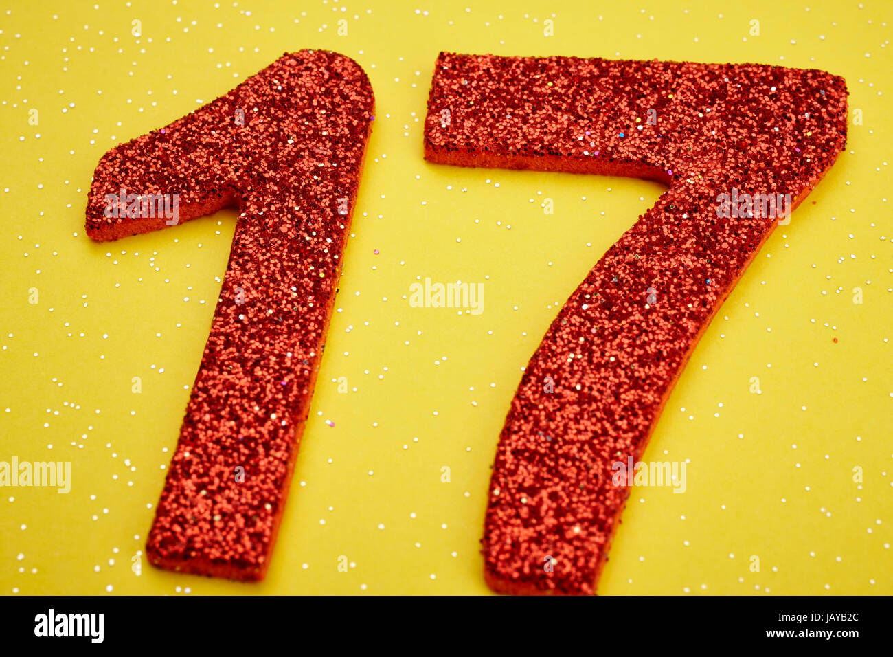 Number seventeen red color over a yellow background. Anniversary ...