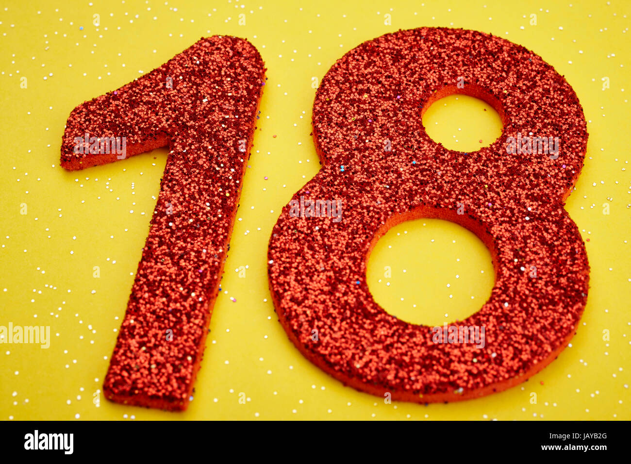 Number eighteen red color over a yellow background. Anniversary ...
