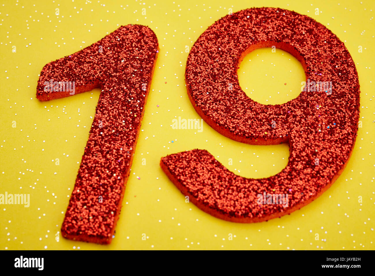 Number nineteen red color over a yellow background. Anniversary ...