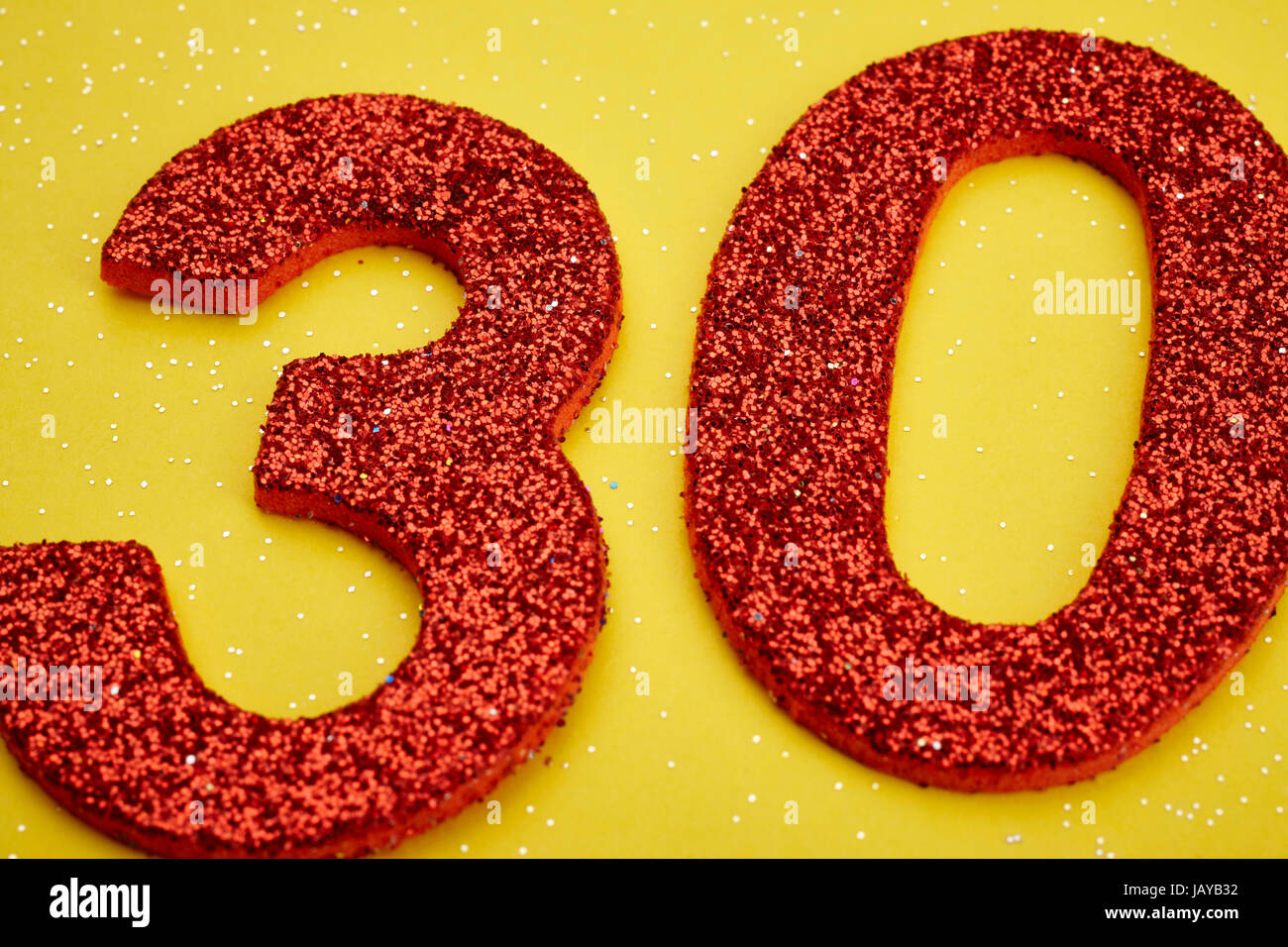Number thirty red color over a yellow background. Anniversary ...