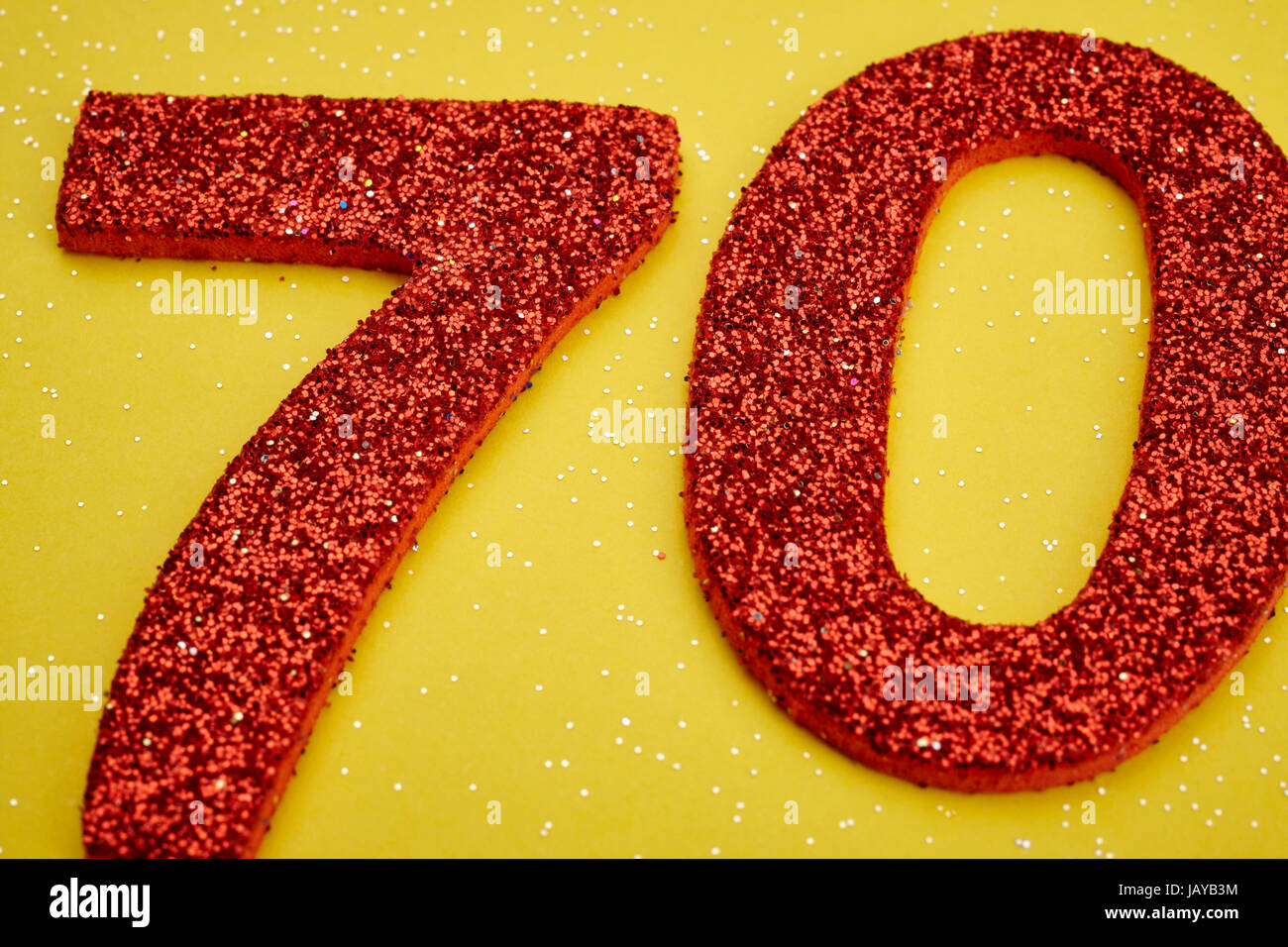 Number seventy red color over a yellow background. Anniversary ...