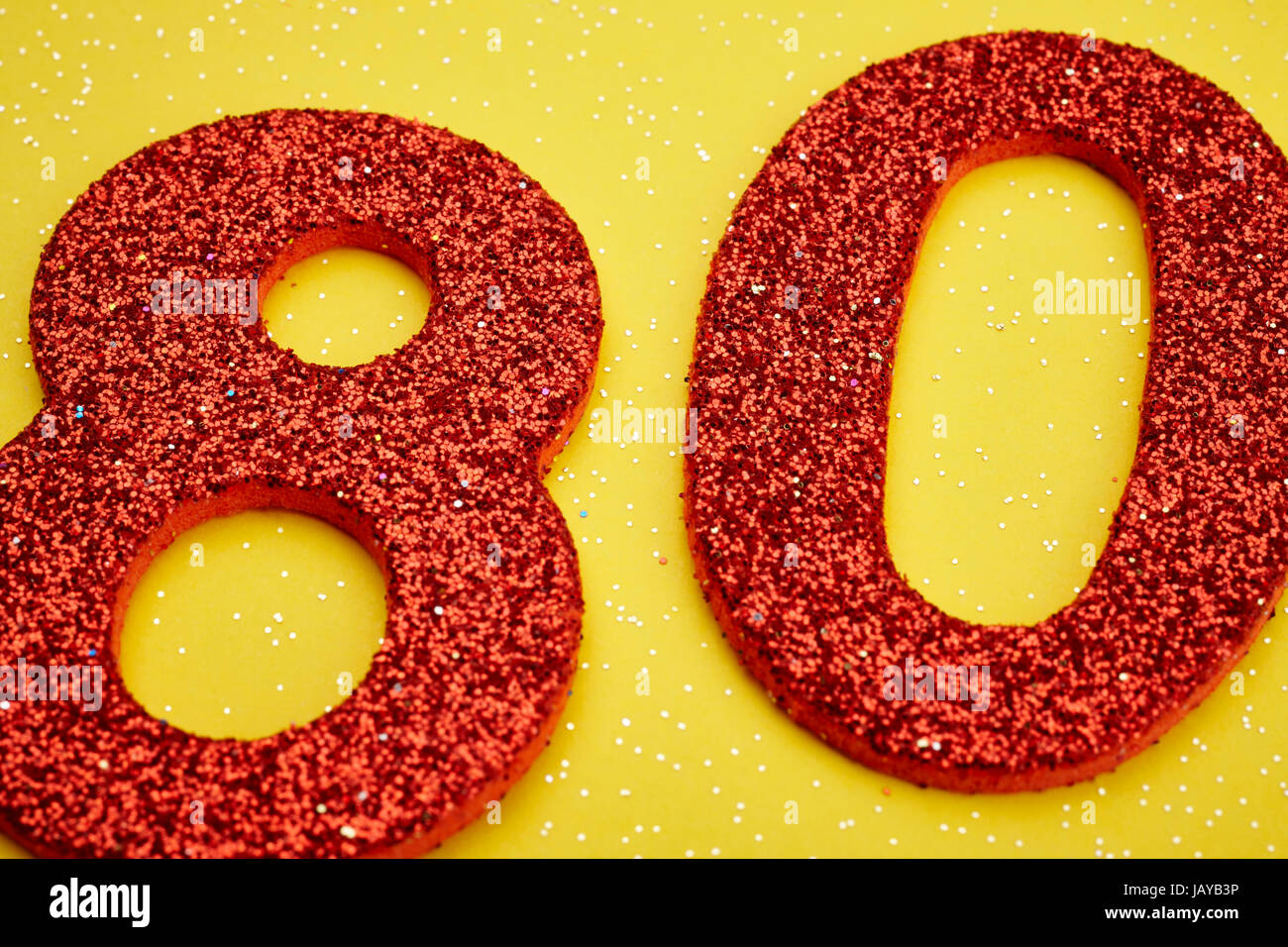 Number eighty red color over a yellow background. Anniversary ...