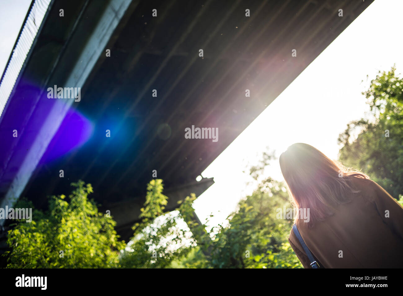 A woman walking under bridge Stock Photo - Alamy