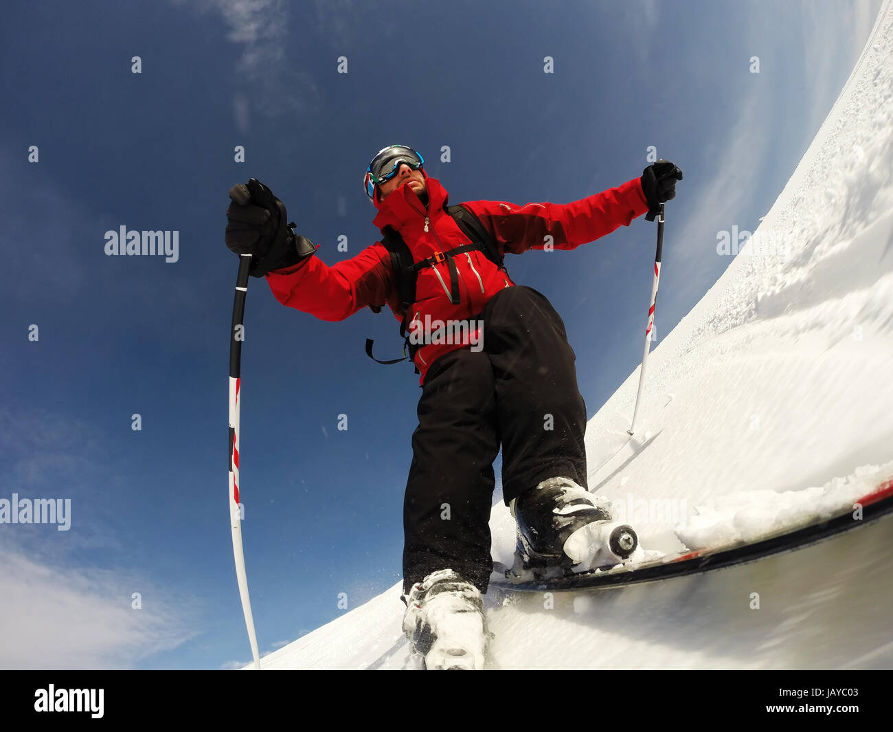 Skier performs a high speed turn on a ski slope. From the ski tip point ...