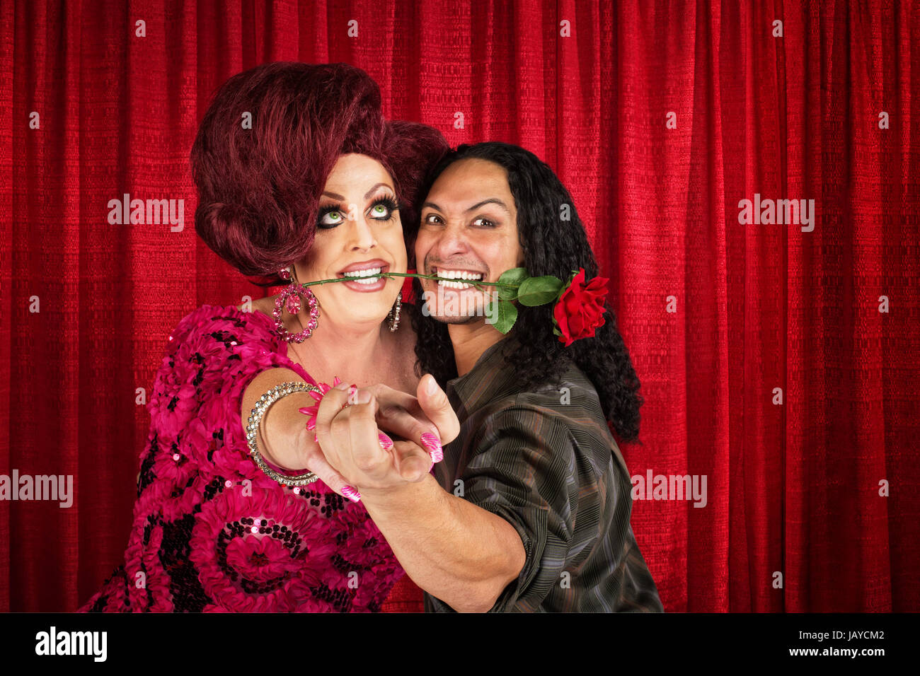 Odd couple dancing with rose in their mouth Stock Photo - Alamy