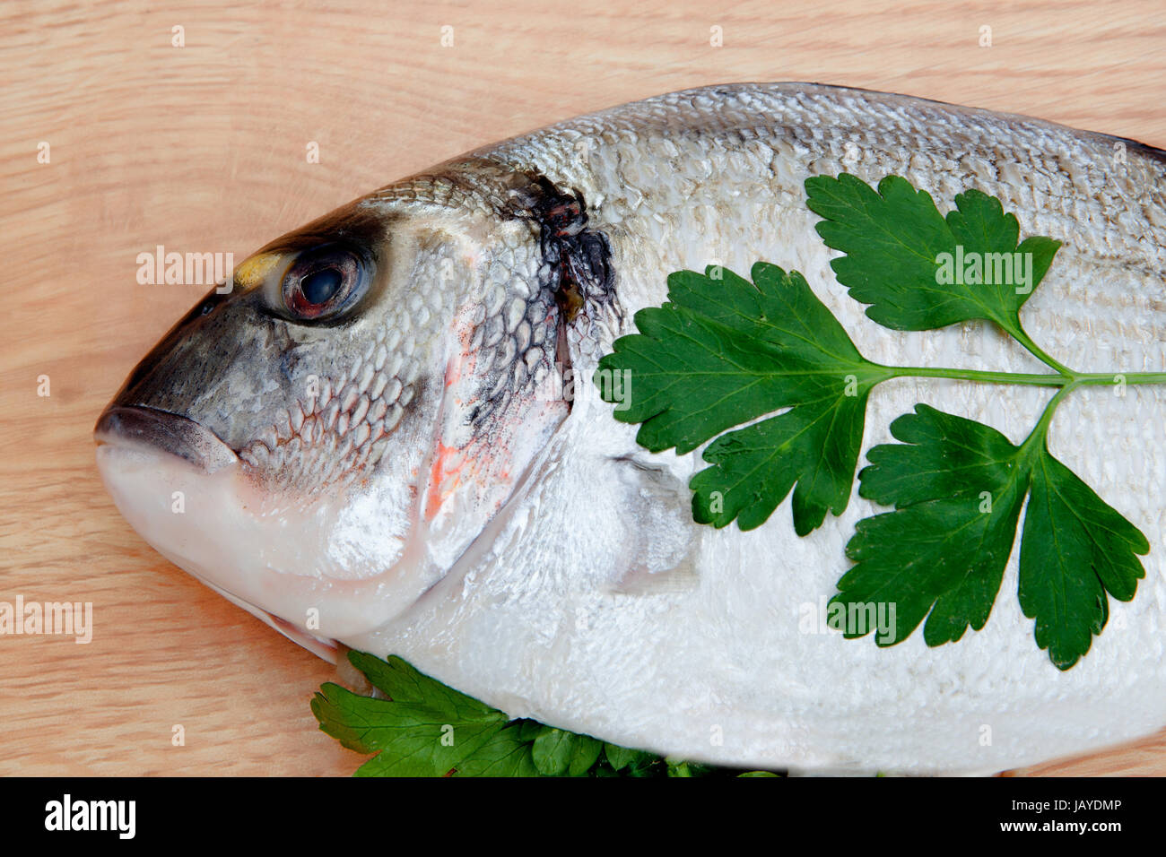 Photo of a healthy fresh fish on wooden board Stock Photo - Alamy