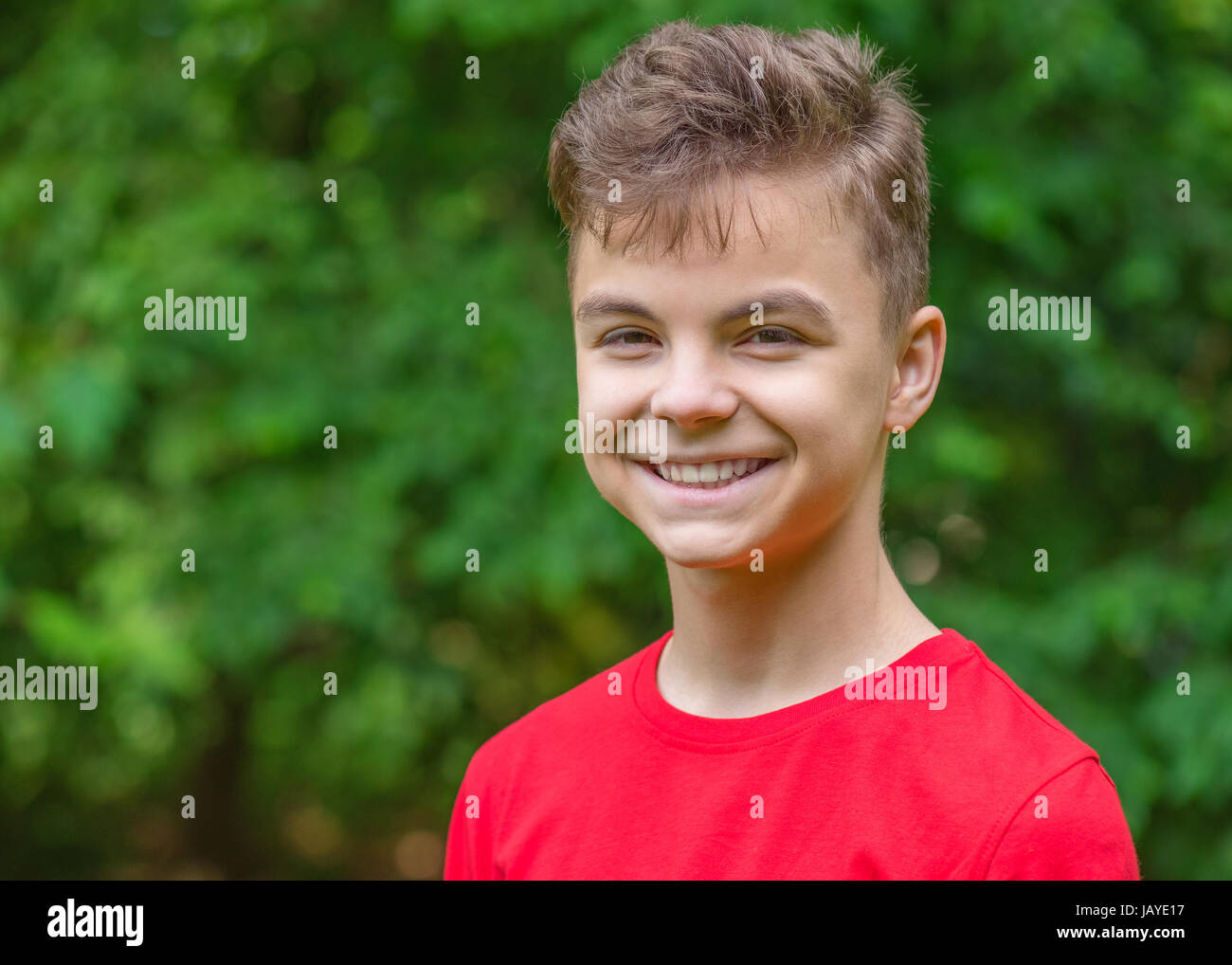 Close up emotional portrait of caucasian smiling teen boy. Head shot of ...