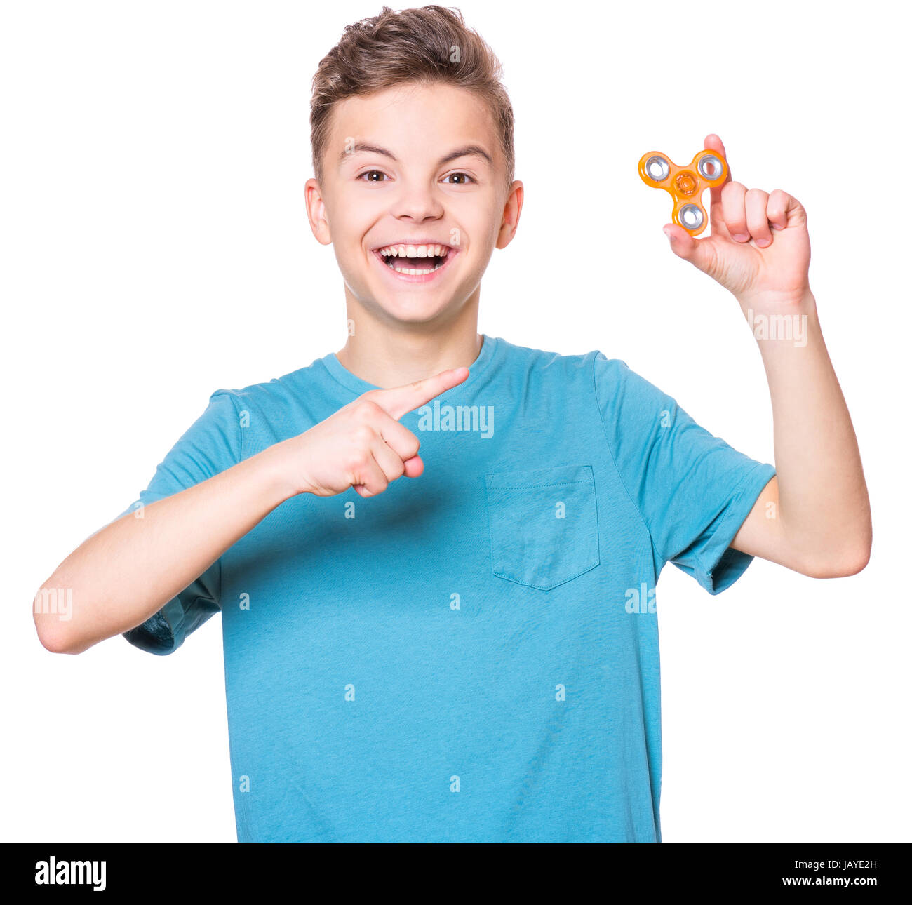 Young teen boy holding popular fidget spinner toy - close up portrait ...