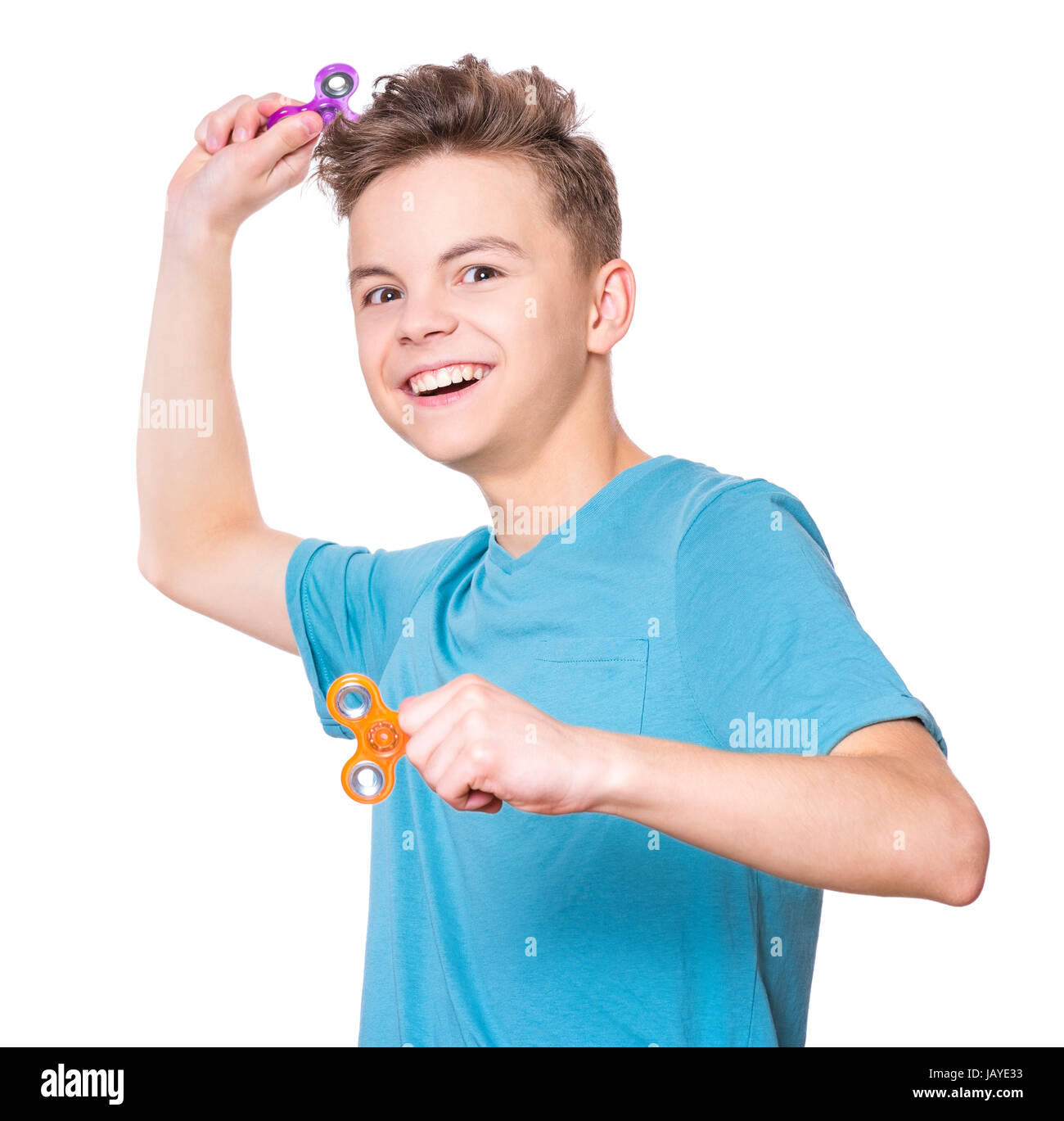 Young teen boy holding popular fidget spinner toy - close up portrait ...