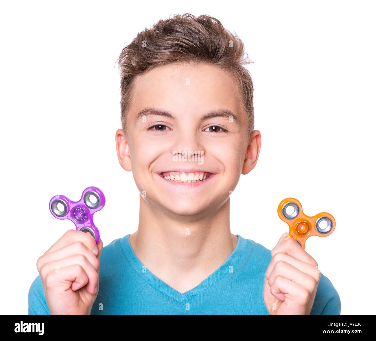 Young teen boy holding popular fidget spinner toy - close up portrait ...