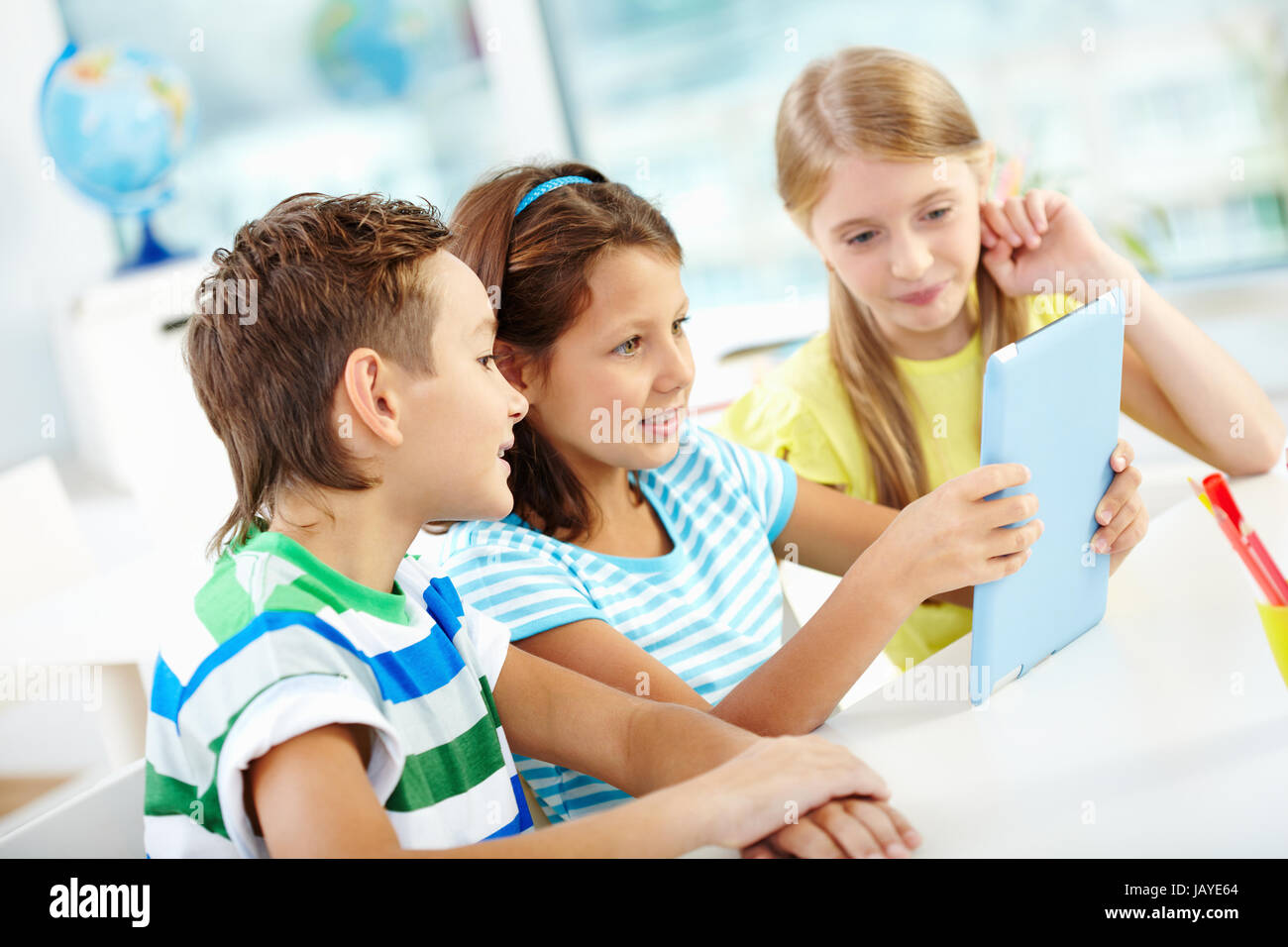 Modern pupils doing their homework with the help of a tablet computer ...