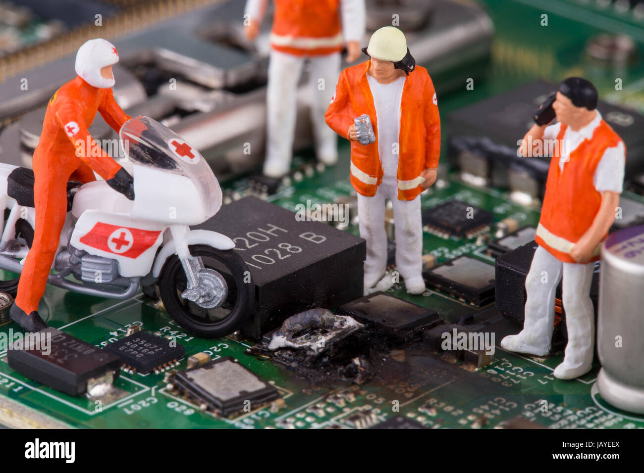 miniature workers on a computer mainboard - studio shot Stock Photo - Alamy