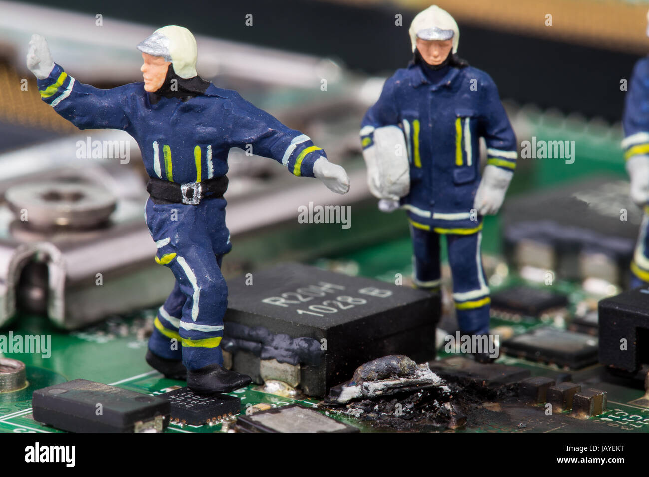 miniature firemen on a computer mainboard - studio shot Stock Photo - Alamy