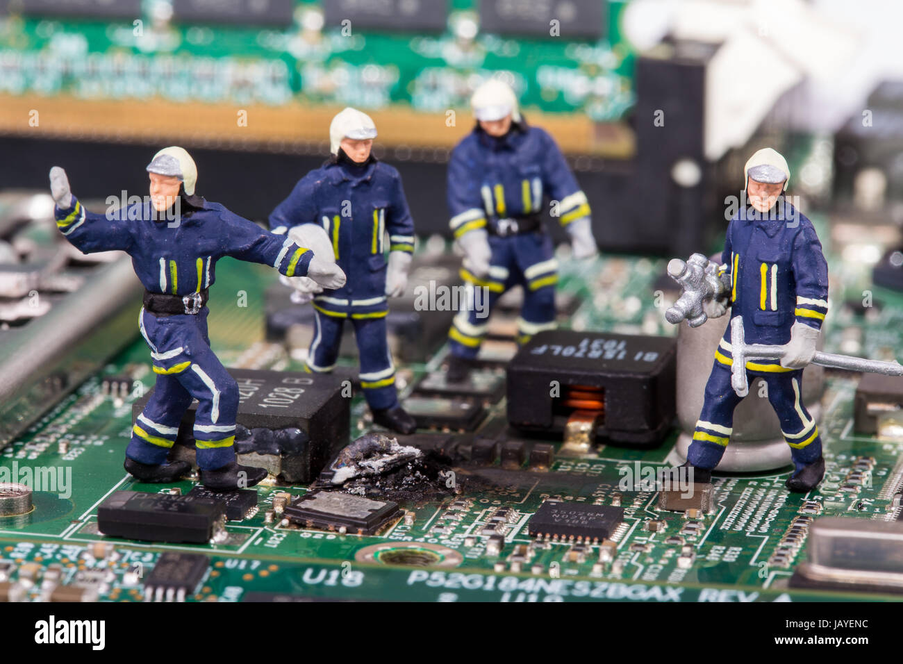 miniature firemen on a computer mainboard - studio shot Stock Photo - Alamy